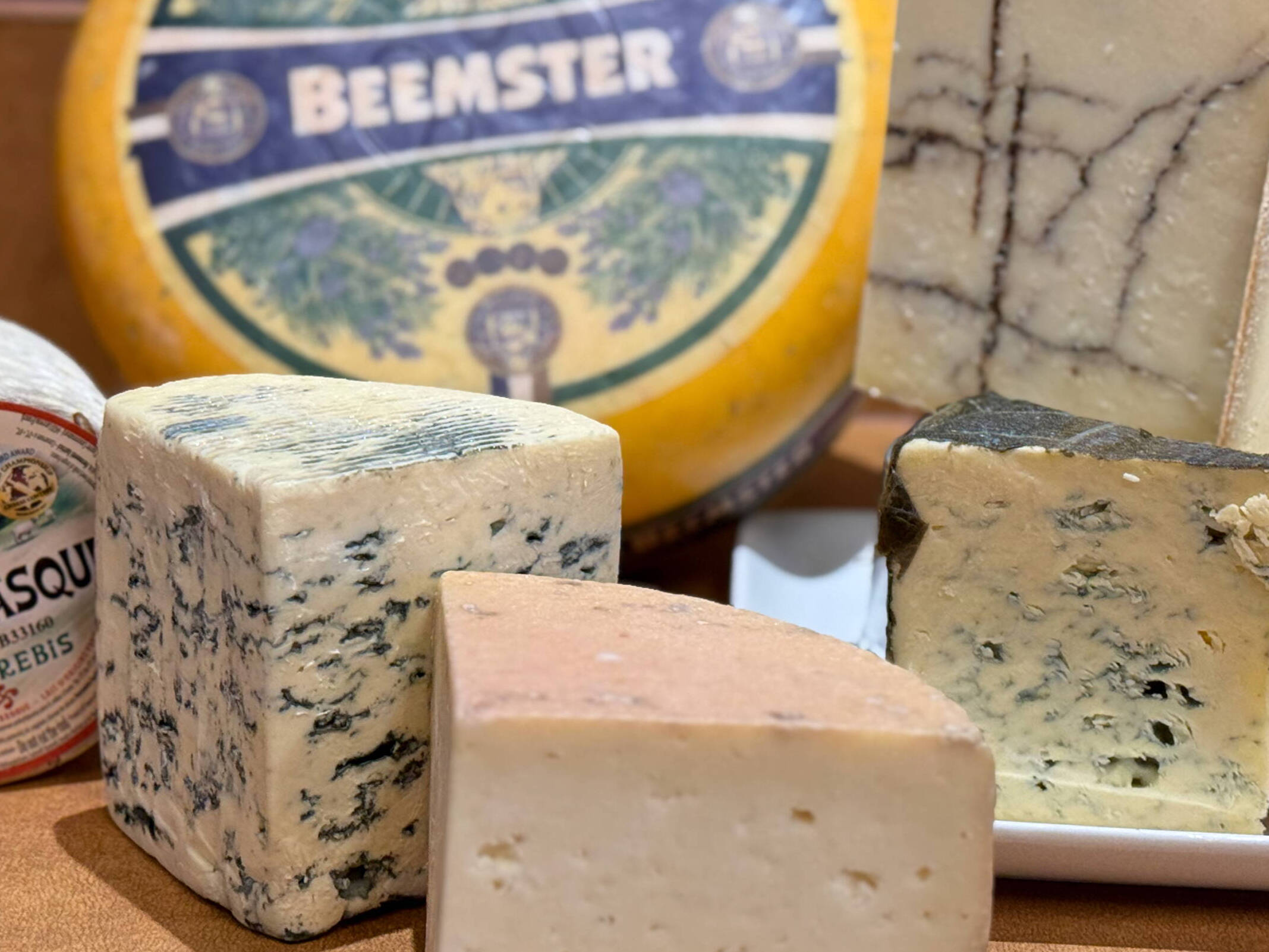 An assortment of artisan cheeses, including blue, aged, and soft ...
